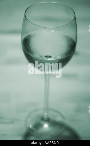White wine in glass on room background Stock Photo - Alamy