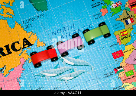 Wooden cars onn large world map puzzle Stock Photo - Alamy