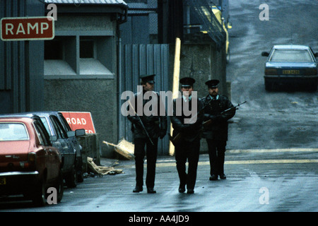 RUC (Royal Ulster Constabulary) officers on patrol in the nationalist ...