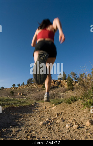 Action shot of a woman trail running Stock Photo - Alamy