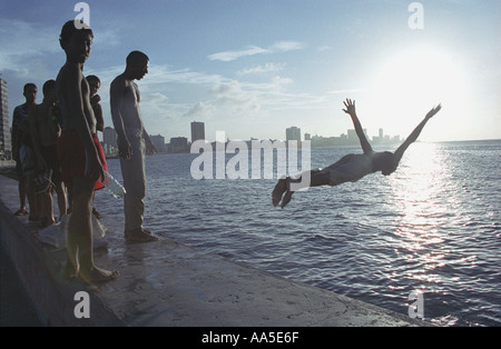Cuban kids playing and diving in the sea from the Malecon in Havana ...