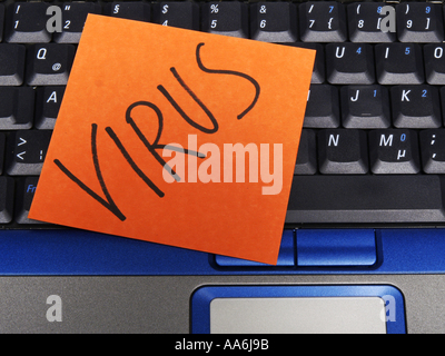 Computer virus, note on the keyboard of a laptop. Computer virus, note ...
