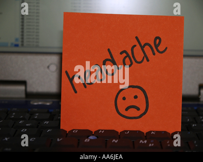 memo note on notebook headache drawing sad smiley Stock Photo - Alamy