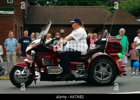 Fat obese motorcycle rider riding past graffiti on Southend seafront ...