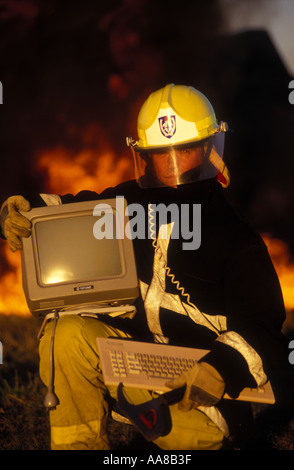 Fireman rescuing computer from flames Stock Photo - Alamy