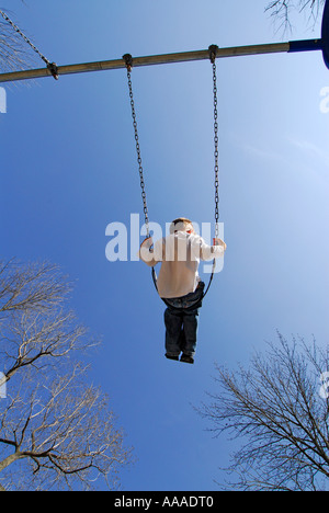 5 year old boy performs daring tricks on a swing Stock Photo - Alamy