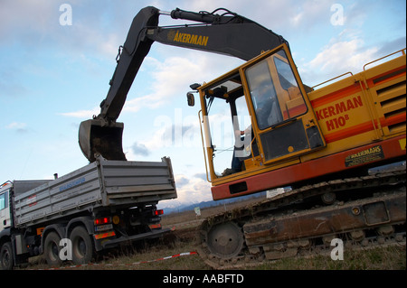 excavator loading earth onto lorry Stock Photo - Alamy