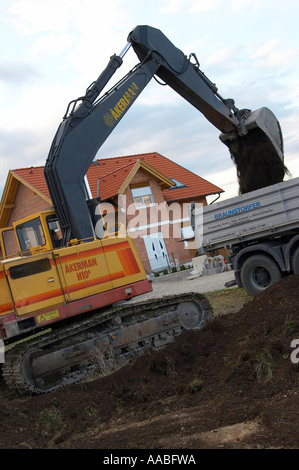 excavator loading earth onto lorry Stock Photo - Alamy