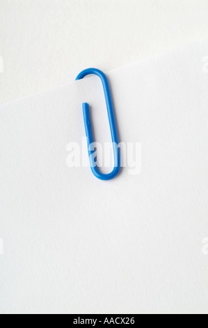 Twisted paperclip and paper Stock Photo - Alamy