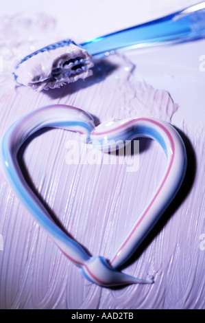 Heart made with toothpaste and brush on white background, top view ...