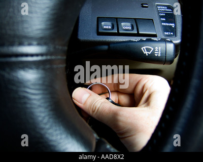 a hand on the ignition key of a car Stock Photo - Alamy