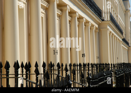 Repeating pattern of numbered stone pillars outside houses designed by ...
