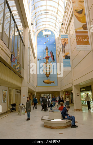 Shoppers looking at the Wishing Fish Clock Regent Arcade Cheltenham UK ...