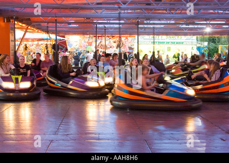 People in bumper cars bumping into each other in a blur at an arcade ...