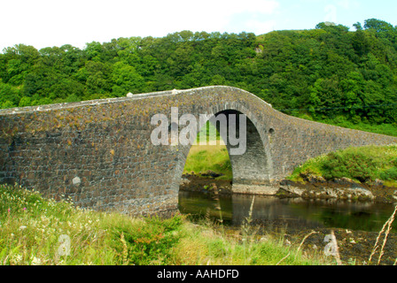 A wet bridge crosses the sea in the background of mountains in the ...