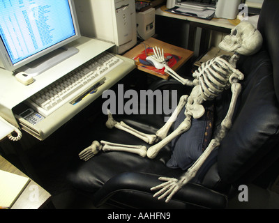 Skeleton using a computer Stock Photo - Alamy