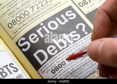 Serious Debts advertisement in Yellow Pages England UK Stock Photo - Alamy