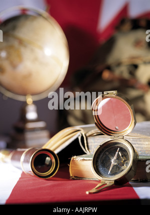 Compass, telescope and the book on the old map Stock Photo - Alamy