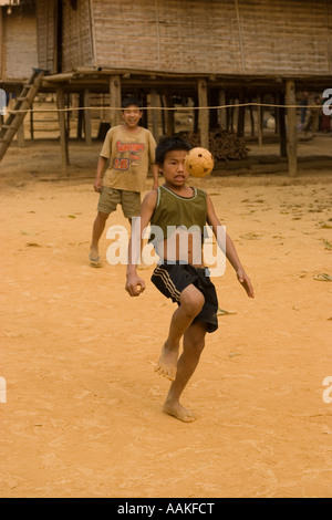 Kids playing ball, sepak takraw, in a village near Muang Ngoi Laos ...