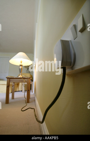 A table lamp plugged into a wall socket in the UK Stock Photo - Alamy
