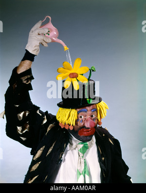 Funny man with watering can Stock Photo - Alamy