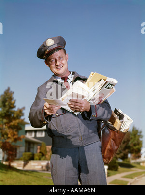 Smiling postman, mailman, letter carrier carrying packages Stock Photo ...