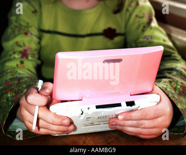 Young girl playing with her pink Nintendo. Game Over is displayed on ...