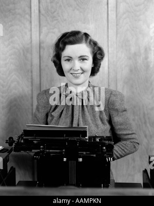 1940s SMILING YOUNG WOMAN SECRETARY RECEPTIONIST SITTING AT OFFICE DESK ...