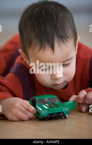 Backside of a little boy playing with toy car Stock Photo - Alamy