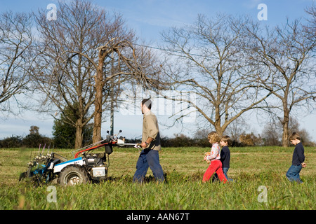 kids following the gardener Stock Photo - Alamy