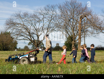 kids following the gardener Stock Photo - Alamy