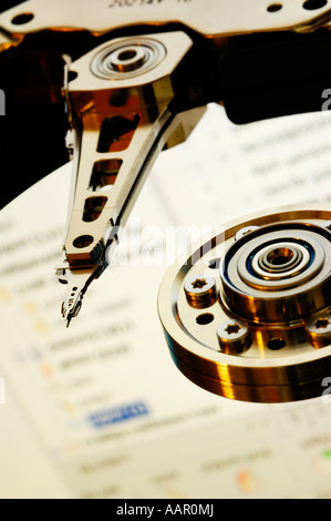 A computer hard disc exposed showing the magnetic disc platter, the ...