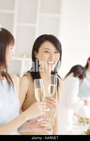 Small group of young women enjoying party at home Stock Photo - Alamy