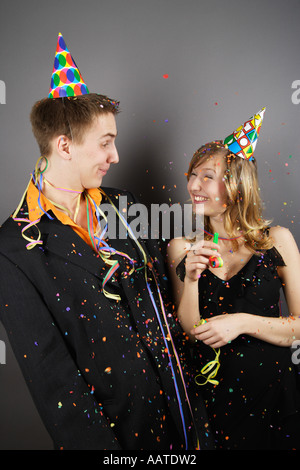 Young man in party hat with gift box celebrating Birthday and showing ...
