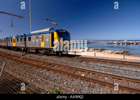 A train going past Kalk Bay harbour on Cape Town's Indian Ocean ...