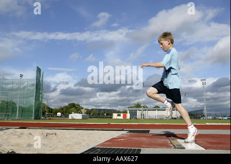 Young Athlete competing in long jump Stock Photo - Alamy
