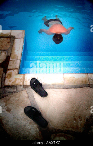 boy floating face down in swimming pool Stock Photo - Alamy