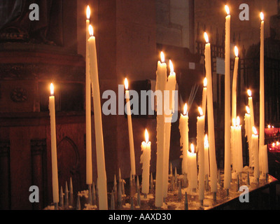 Burning candles in the Catholic Church. Selective focus. Bokeh. Red and ...