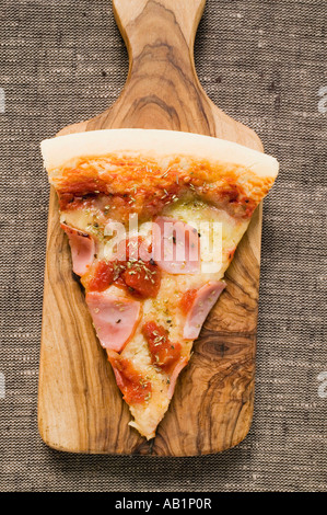 Slice of ham pizza on server FoodCollection Stock Photo - Alamy