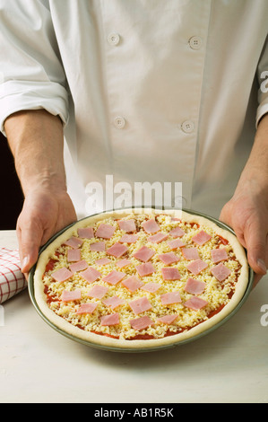 Topping a pizza with ham FoodCollection Stock Photo - Alamy