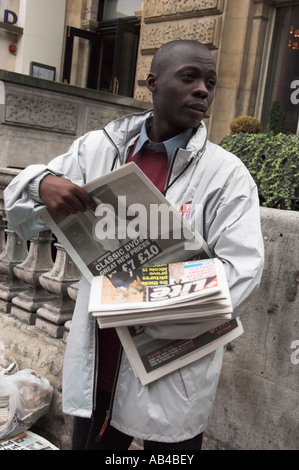 London newspaper vendor distributing free newspapers on High Holborn ...