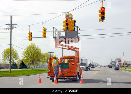 Maintenance crew works to restore fix and refurbish a street traffic ...
