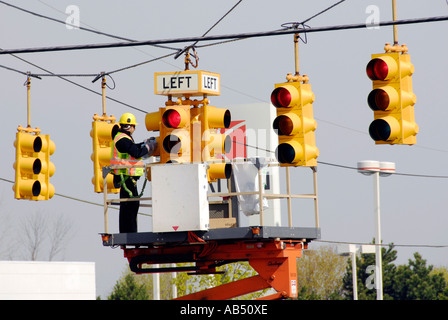 Maintenance crew works to restore fix and refurbish a street traffic ...