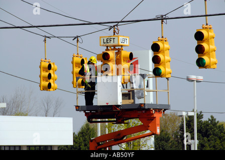 Maintenance crew works to restore fix and refurbish a street traffic ...