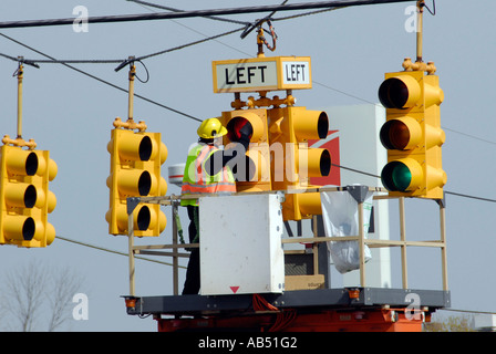 Maintenance crew works to restore fix and refurbish a street traffic ...
