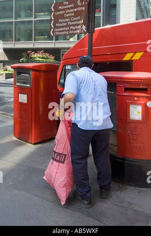 postman emptying letter box Stock Photo - Alamy