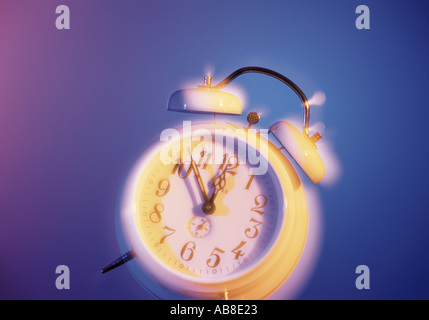 A close-up shot of an alarm clock on a wooden surface with bokeh lights ...