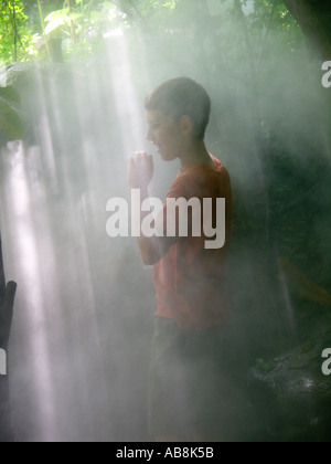 pondering kid in white shirt on red background. childhood. thinking ...