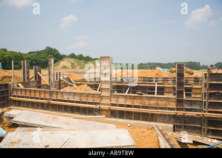 Construction workers work at the site of a condo tower under ...