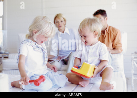 Kids fighting over a toy Stock Photo - Alamy